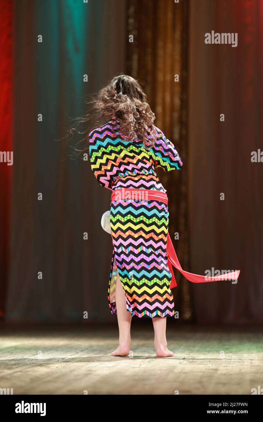 Girls dancers perform on stage with multi-colored lights. Backstage ...