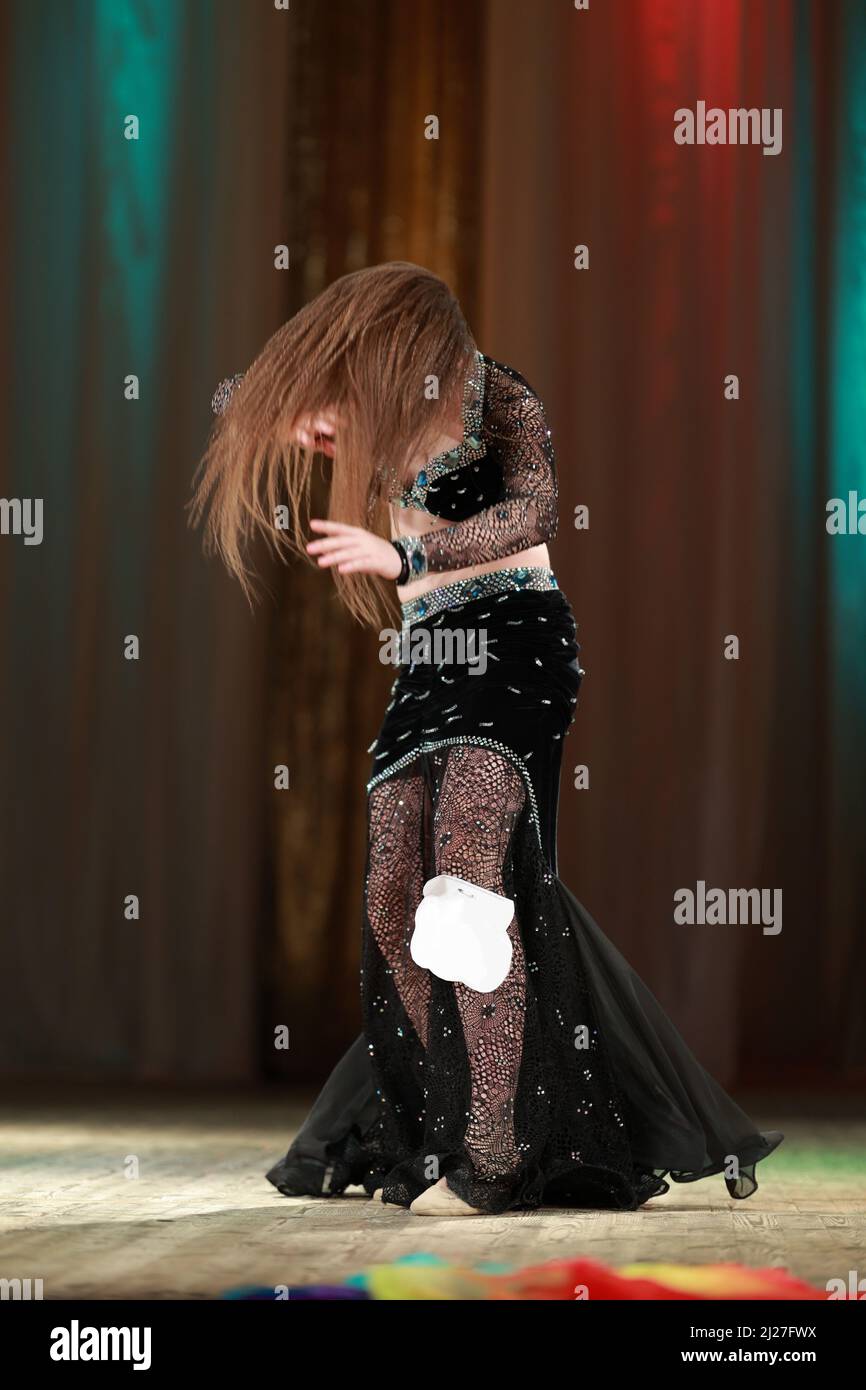 Girls dancers perform on stage with multi-colored lights. Backstage ...