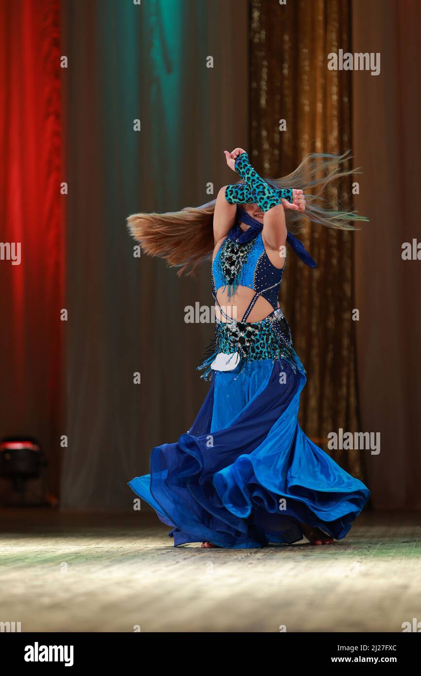 Girls dancers perform on stage with multi-colored lights. Backstage ...