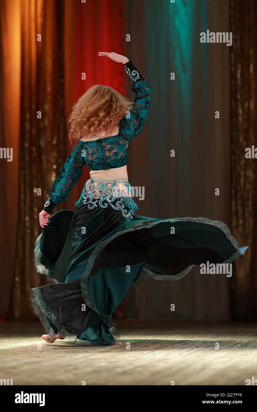 Girls dancers perform on stage with multi-colored lights. Backstage ...