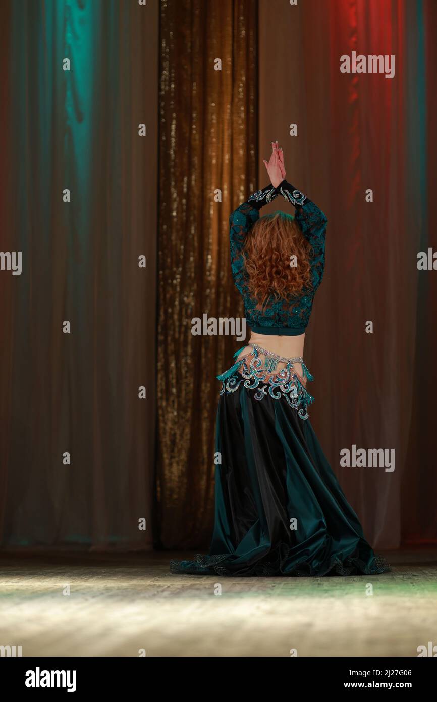 Girls dancers perform on stage with multi-colored lights. Backstage ...