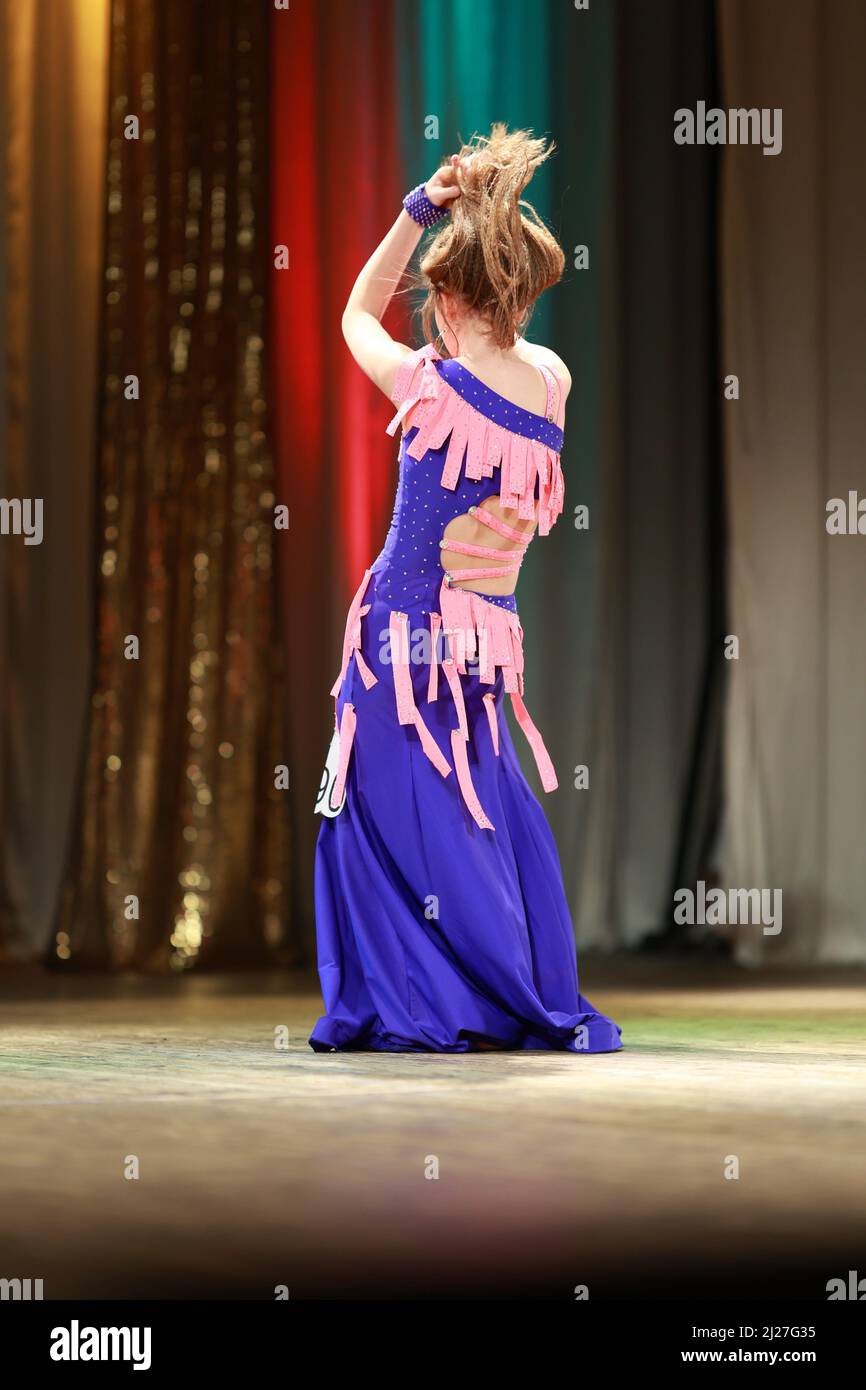 Girls dancers perform on stage with multi-colored lights. Backstage ...