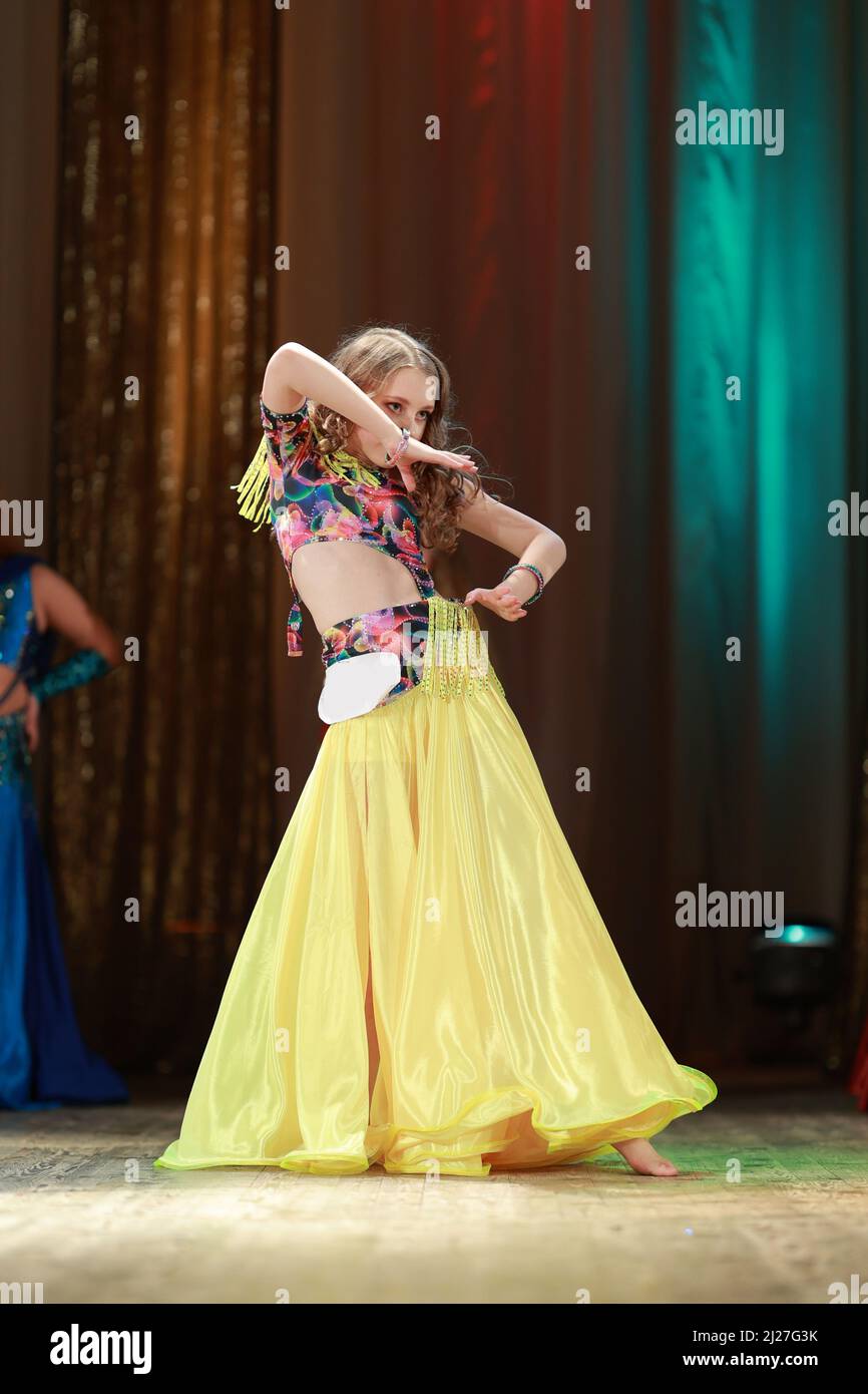 Girls dancers perform on stage with multi-colored lights. Backstage ...