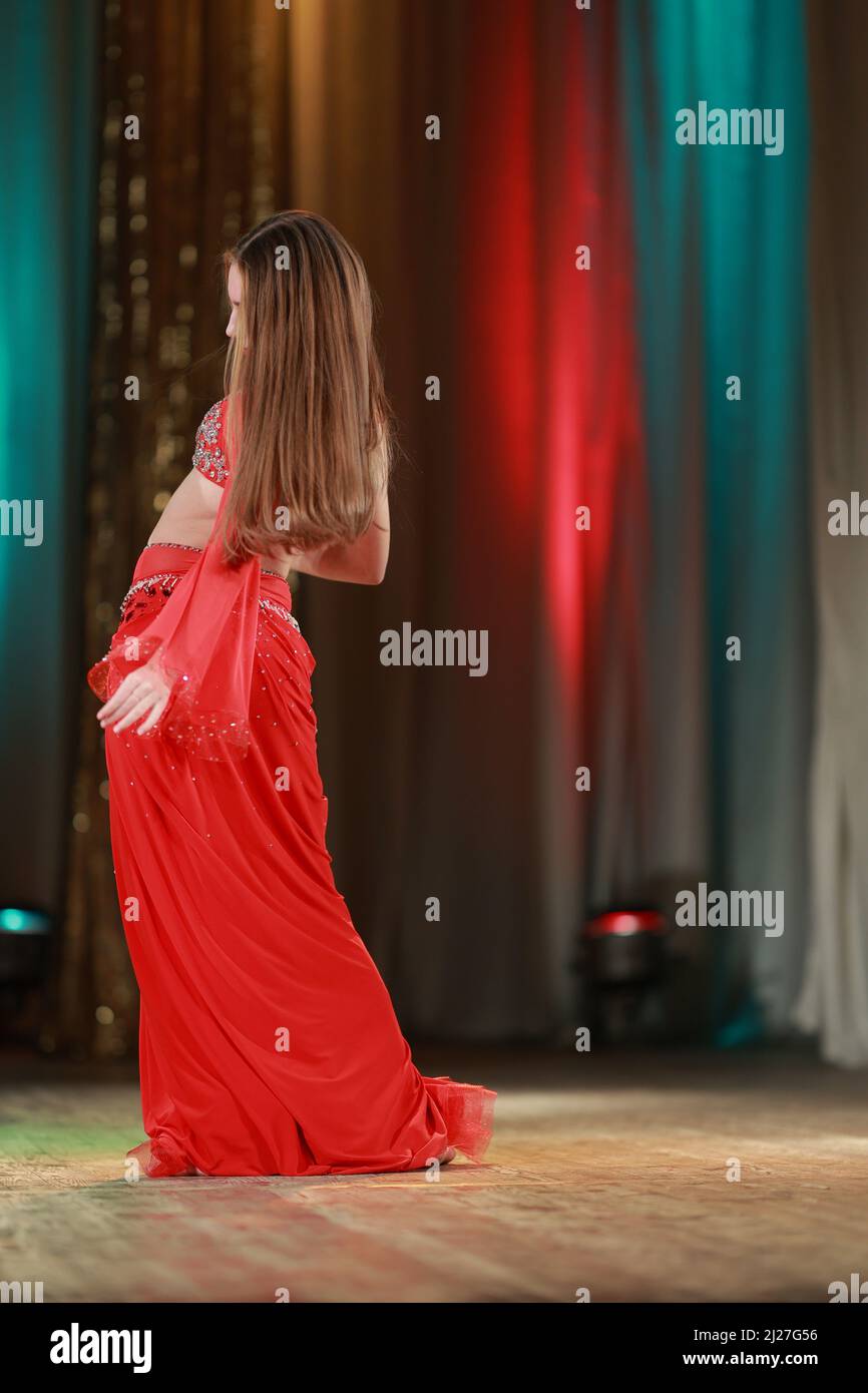 Girls dancers perform on stage with multi-colored lights. Backstage ...