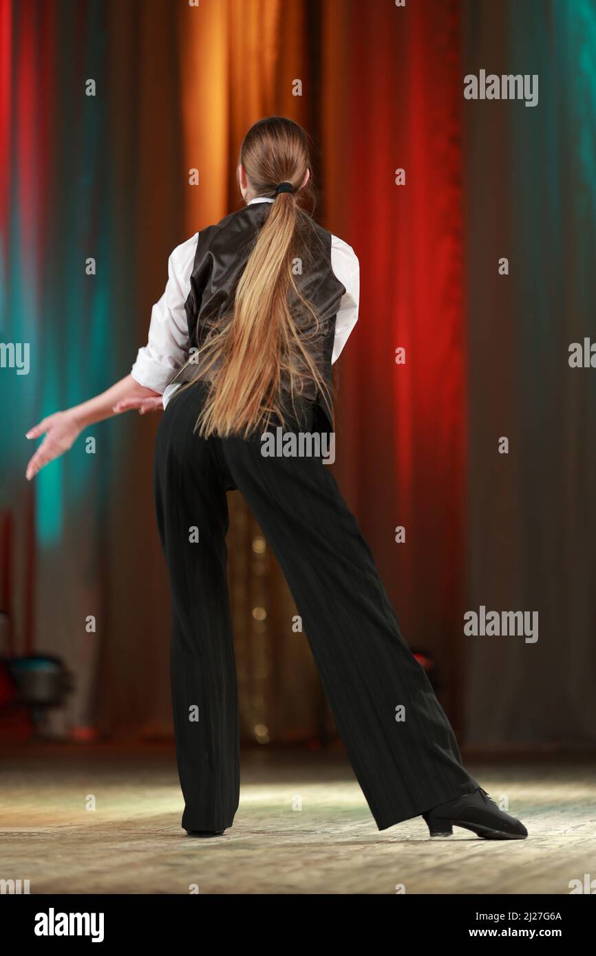 Girls dancers perform on stage with multi-colored lights. Backstage ...