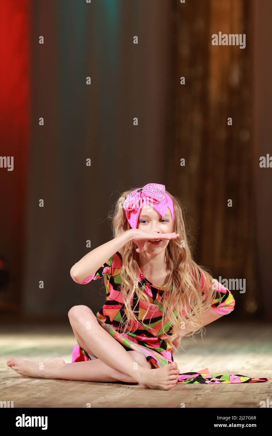 Girls dancers perform on stage with multi-colored lights. Backstage ...
