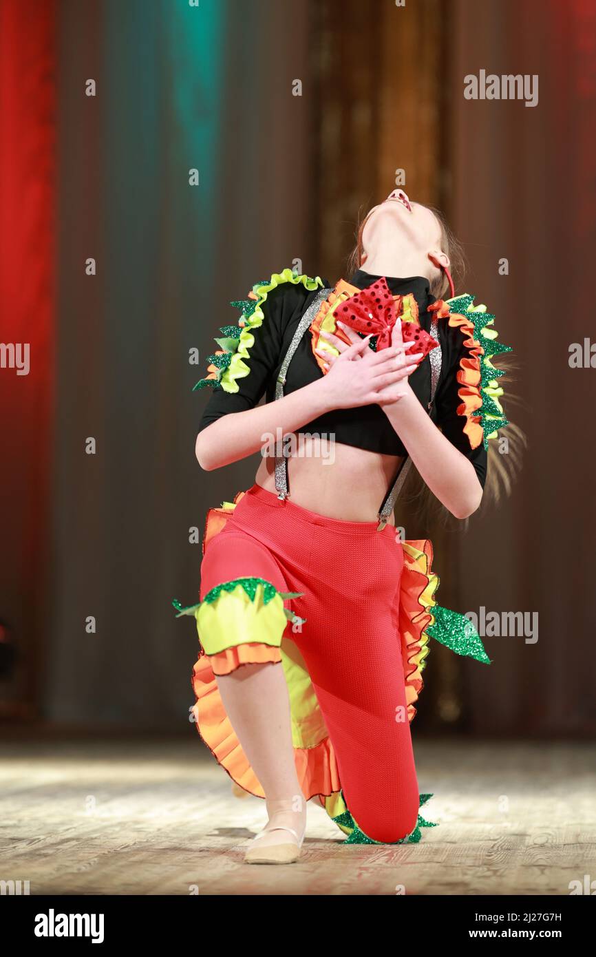 Girls dancers perform on stage with multi-colored lights. Backstage ...