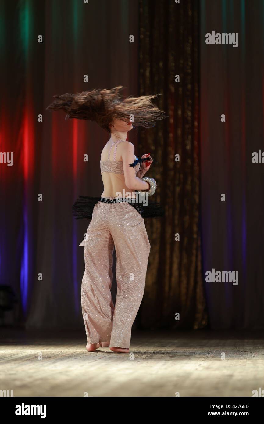 Girls dancers perform on stage with multi-colored lights. Backstage ...