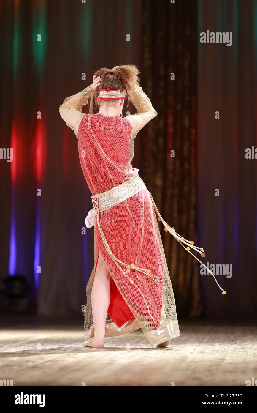 Girls dancers perform on stage with multi-colored lights. Backstage ...