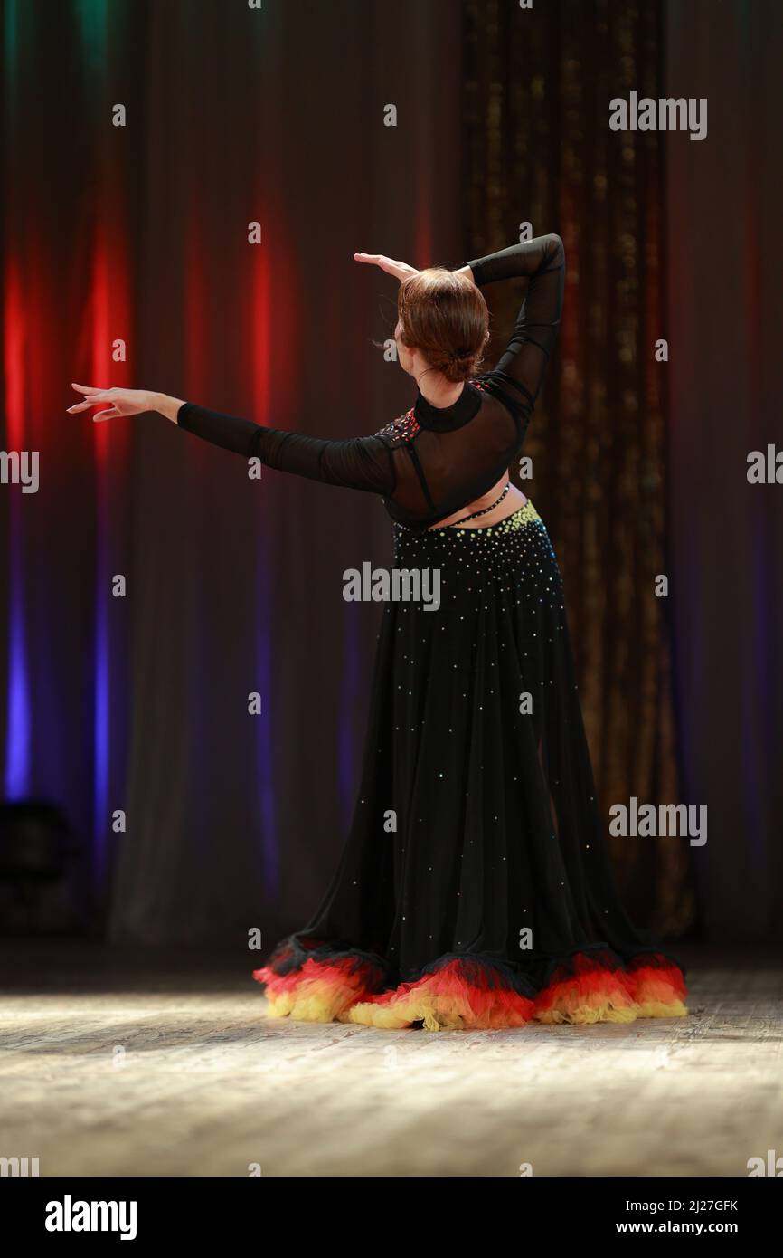 Girls dancers perform on stage with multi-colored lights. Backstage ...