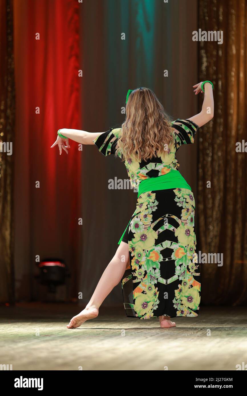 Girls dancers perform on stage with multi-colored lights. Backstage ...