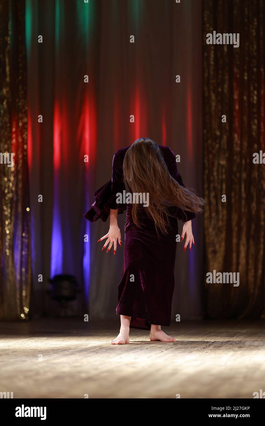 Girls dancers perform on stage with multi-colored lights. Backstage ...