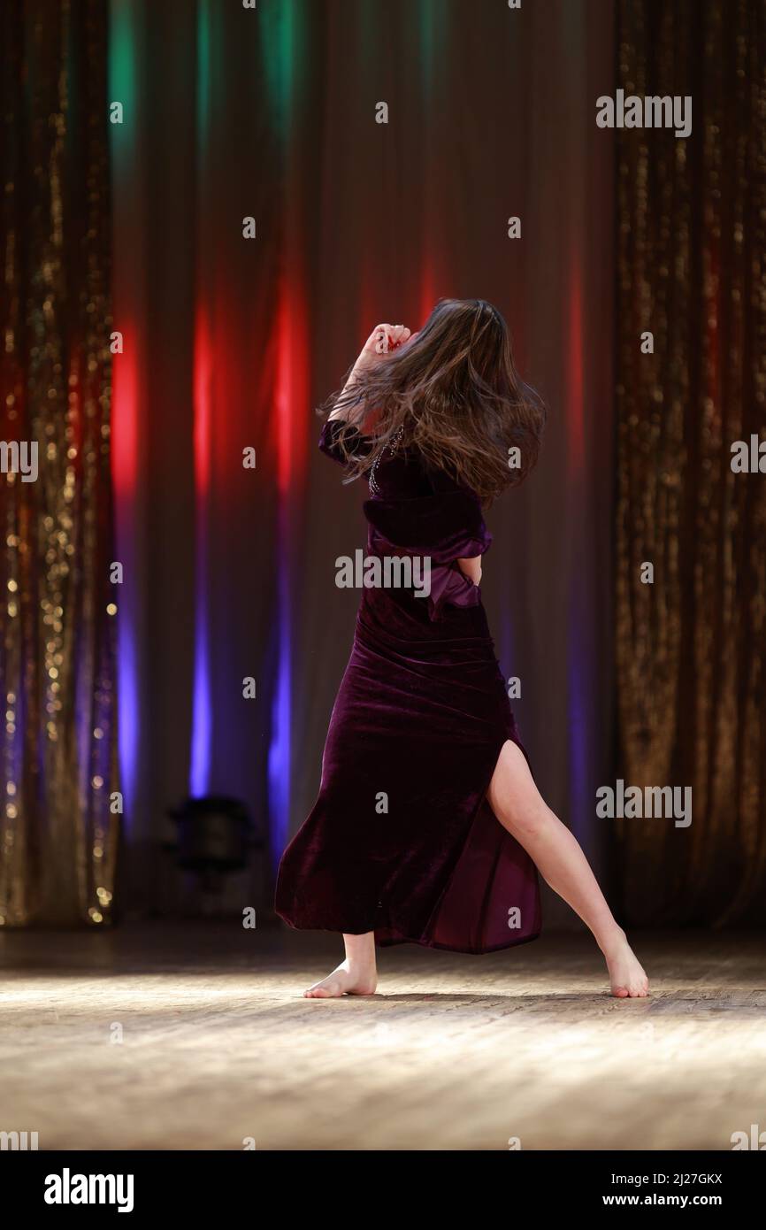 Girls dancers perform on stage with multi-colored lights. Backstage ...