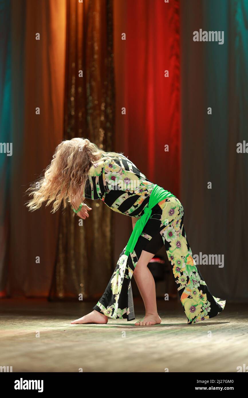 Girls dancers perform on stage with multi-colored lights. Backstage ...