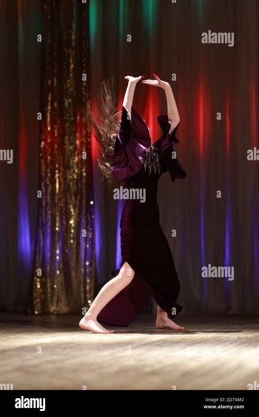 Girls dancers perform on stage with multi-colored lights. Backstage ...