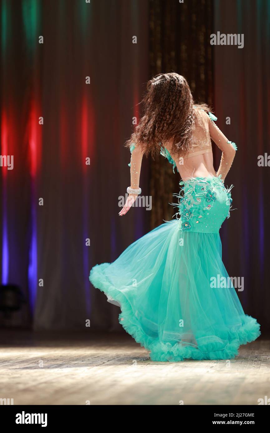 Girls dancers perform on stage with multi-colored lights. Backstage ...