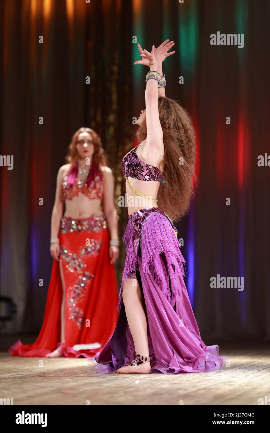 Girls dancers perform on stage with multi-colored lights. Backstage ...