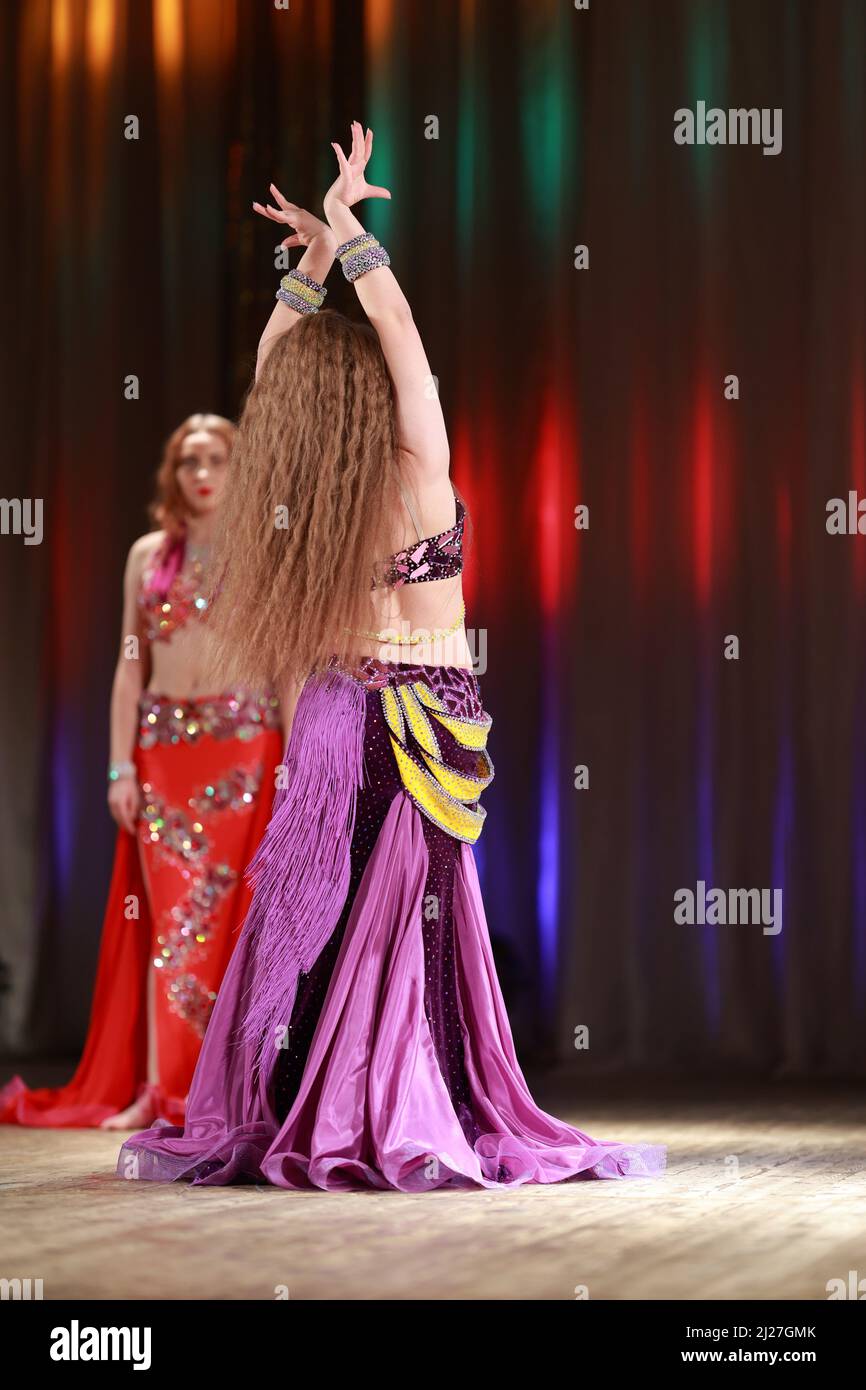 Girls dancers perform on stage with multi-colored lights. Backstage ...