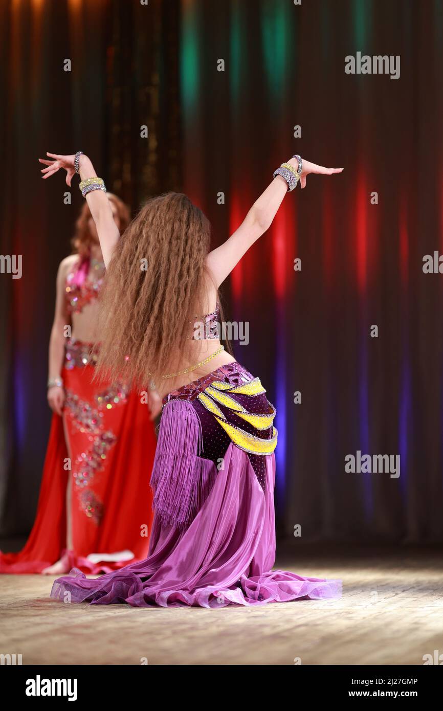 Girls dancers perform on stage with multi-colored lights. Backstage ...