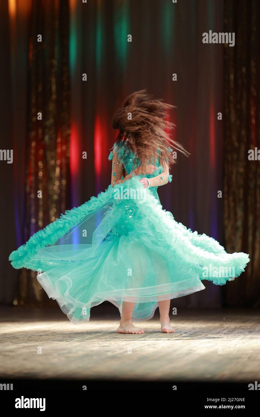 Girls dancers perform on stage with multi-colored lights. Backstage ...