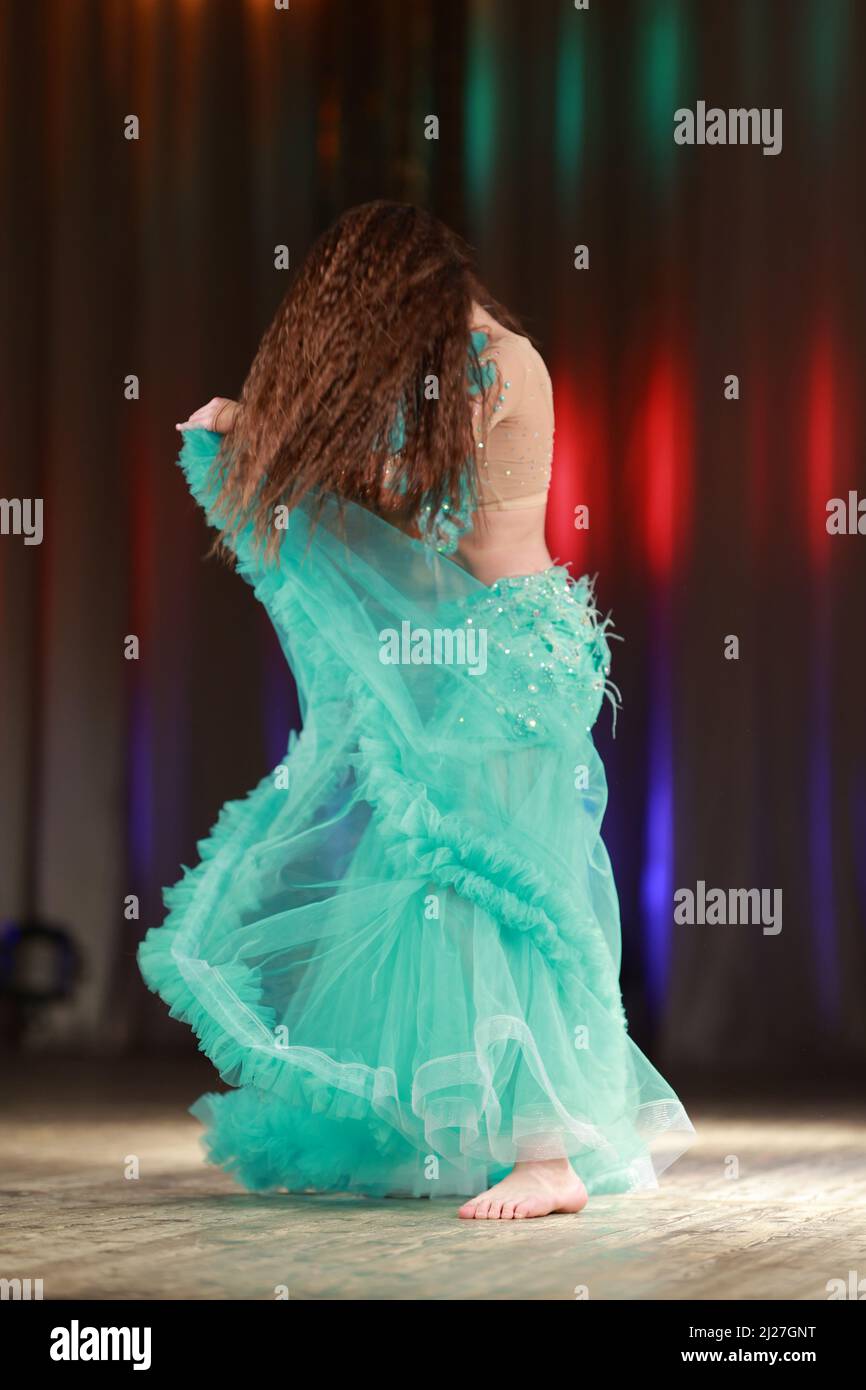 Girls dancers perform on stage with multi-colored lights. Backstage ...