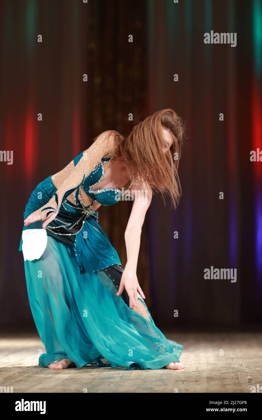 Girls dancers perform on stage with multi-colored lights. Backstage ...