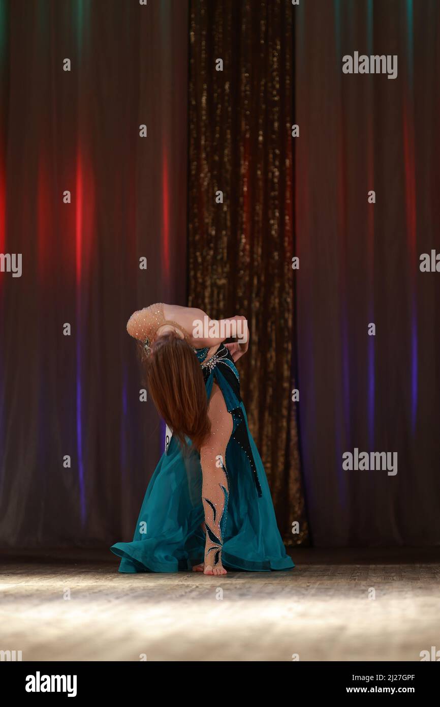 Girls dancers perform on stage with multi-colored lights. Backstage ...