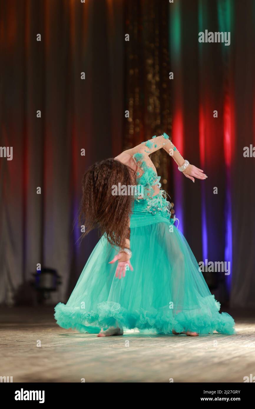 Girls dancers perform on stage with multi-colored lights. Backstage ...