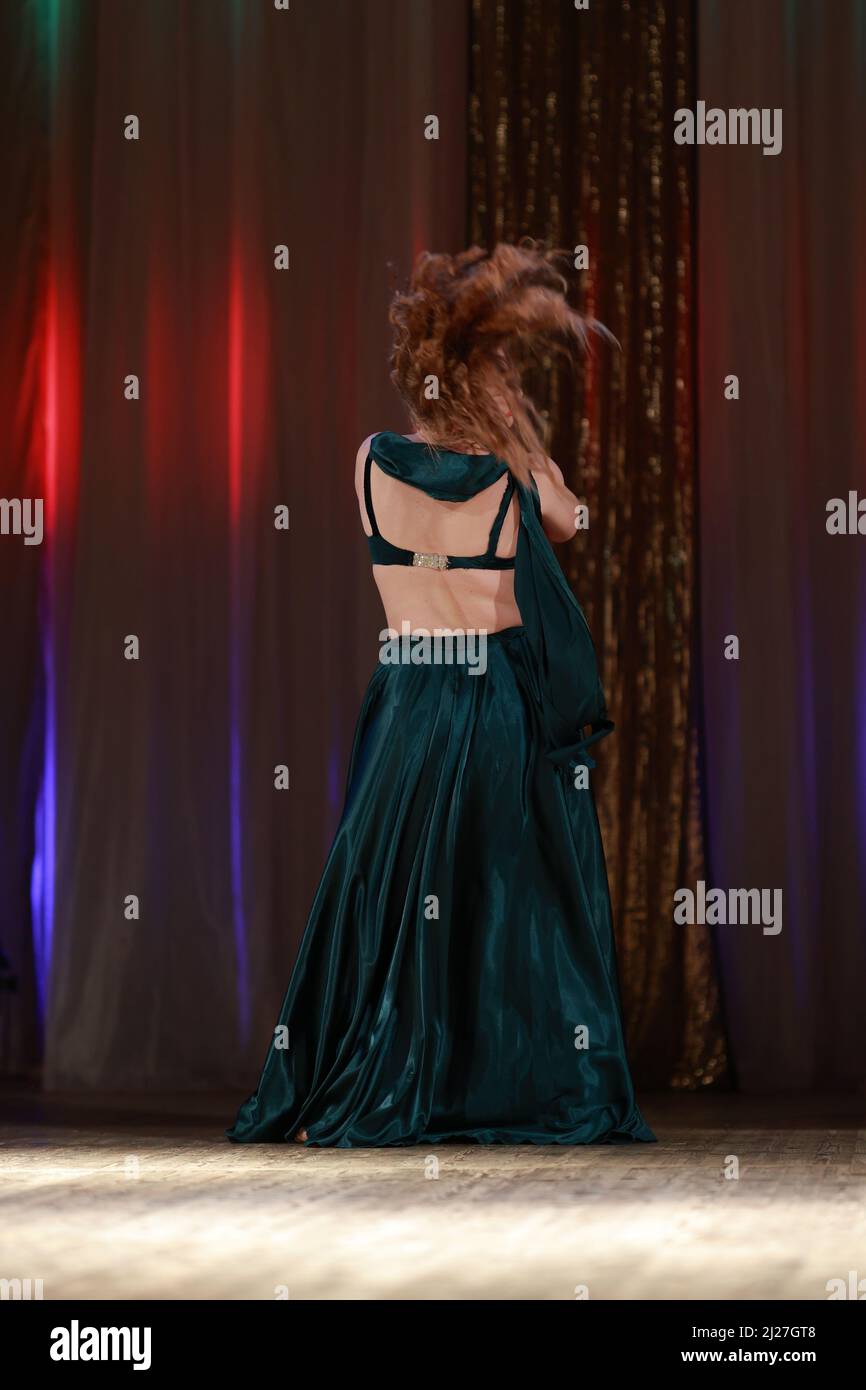 Girls dancers perform on stage with multi-colored lights. Backstage ...