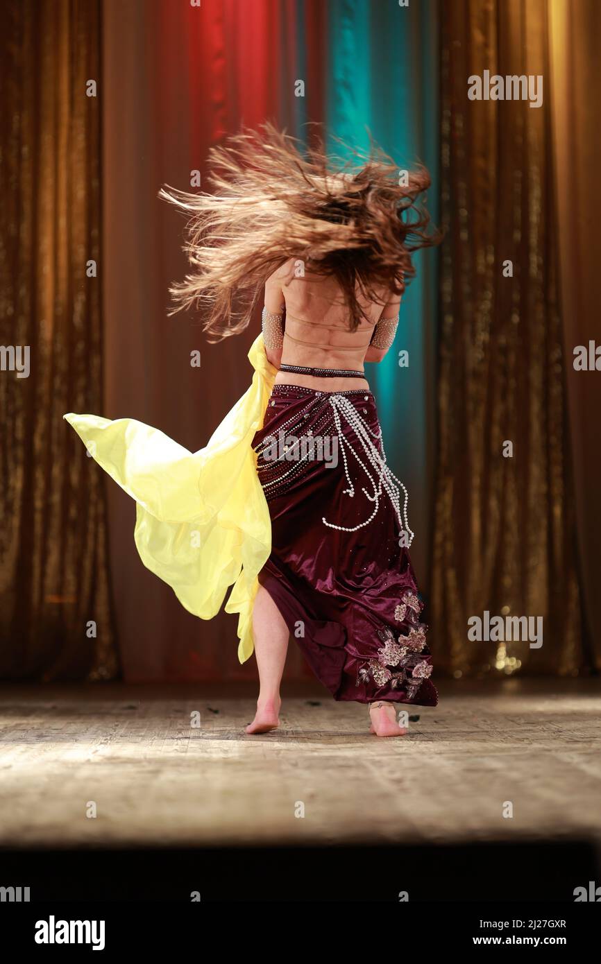 Girls dancers perform on stage with multi-colored lights. Backstage ...