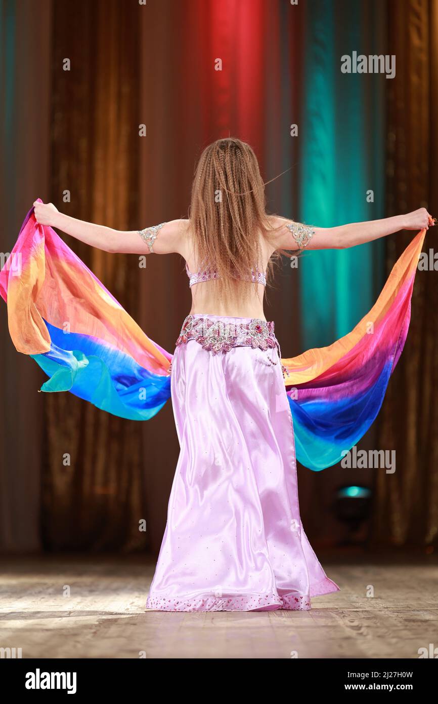 Girls dancers perform on stage with multi-colored lights. Backstage ...