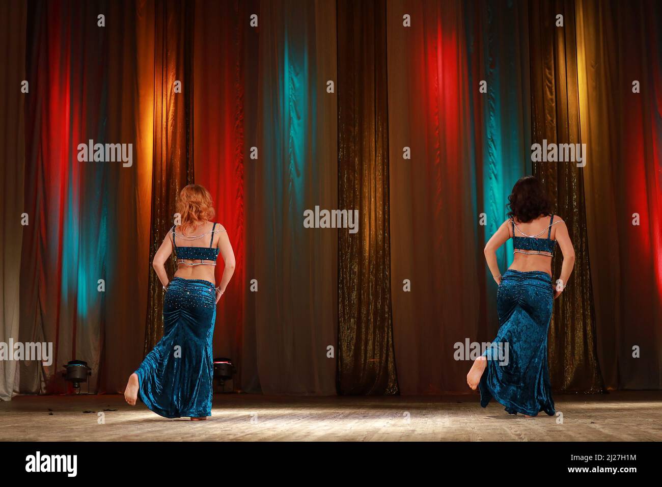 Girls dancers perform on stage with multi-colored lights. Backstage ...