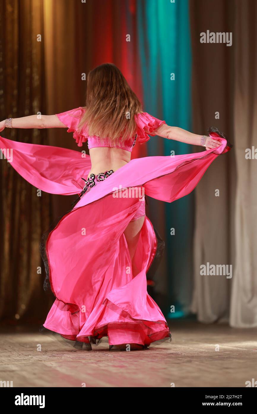Girls dancers perform on stage with multi-colored lights. Backstage ...