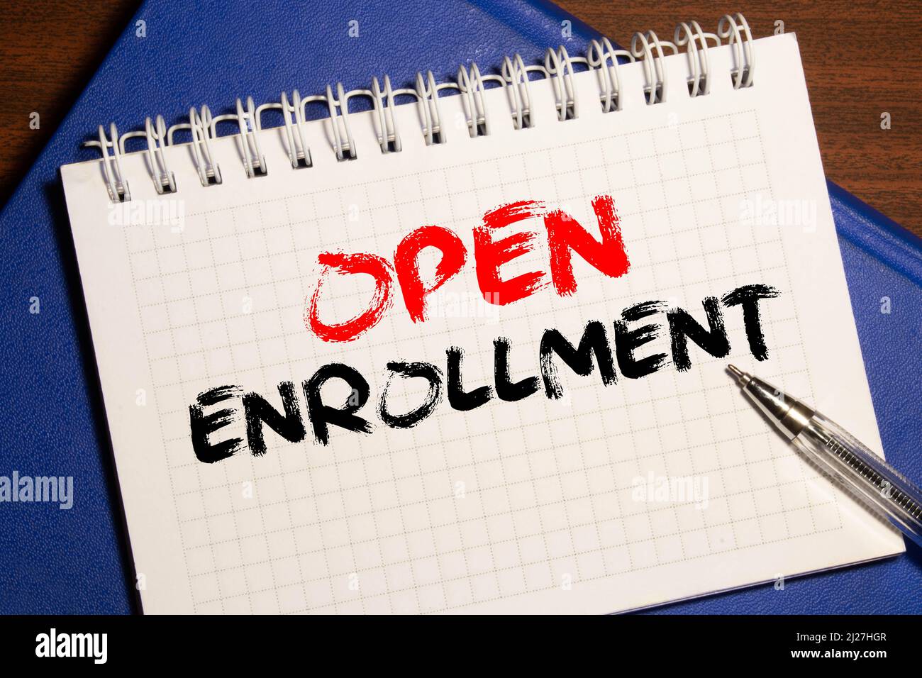 Doctor's desk with notebook and text - Open Enrollment Stock Photo - Alamy