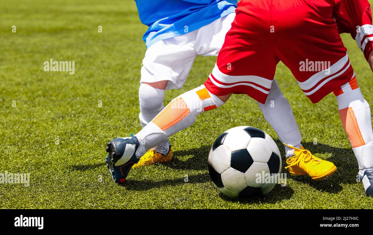 Boys play soccer. Teenagers playing soccer in sports field. Children ...
