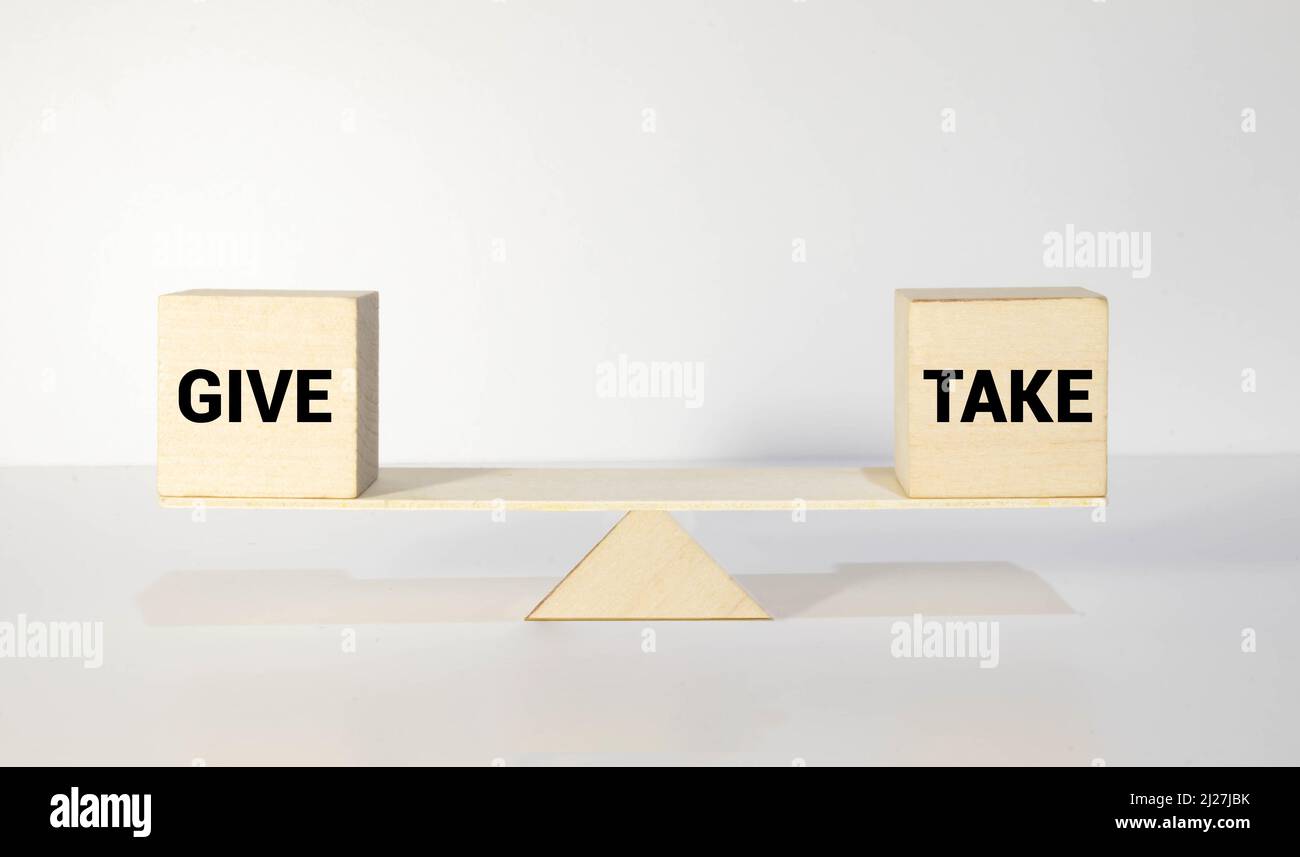Give and Take text on wooden block, business concept Stock Photo - Alamy
