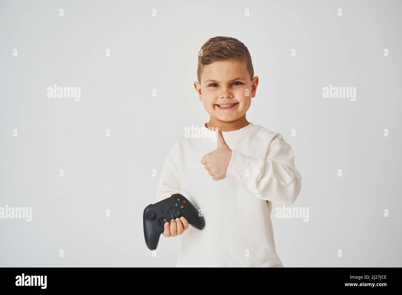 Handsome kid with gamepad on white background. Handsome boy gamer ...