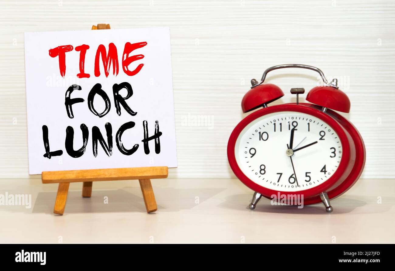 Chalkboard with the words lunch time written on it isolated against a ...