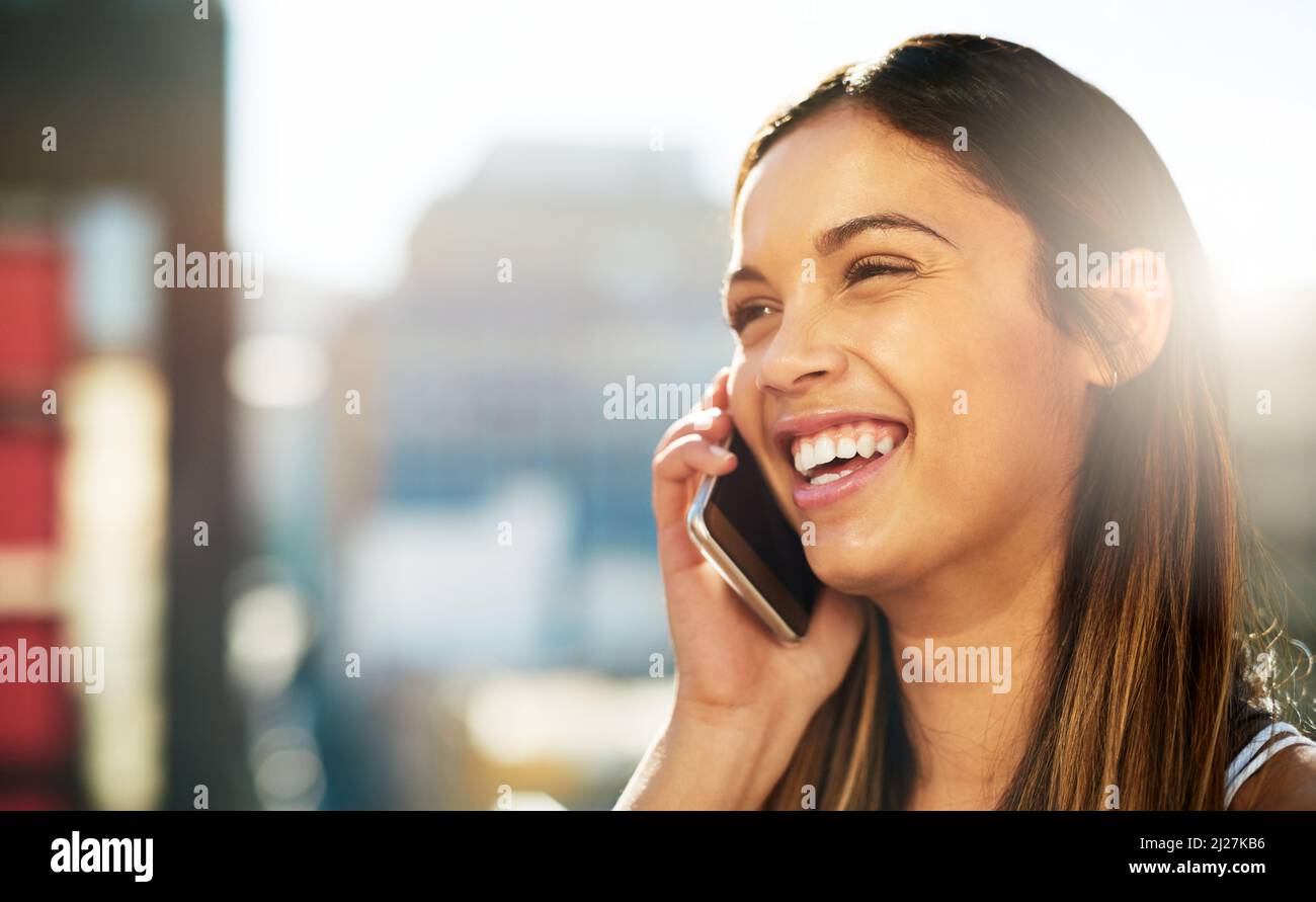 On the call anywhere, anytime. Shot of a beautiful young woman on a ...