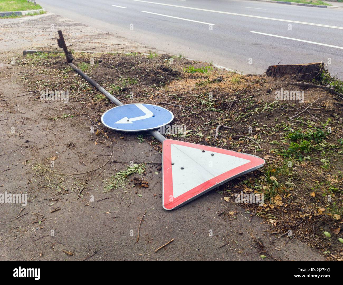 Fallen road sign "Give way Stock Photo - Alamy