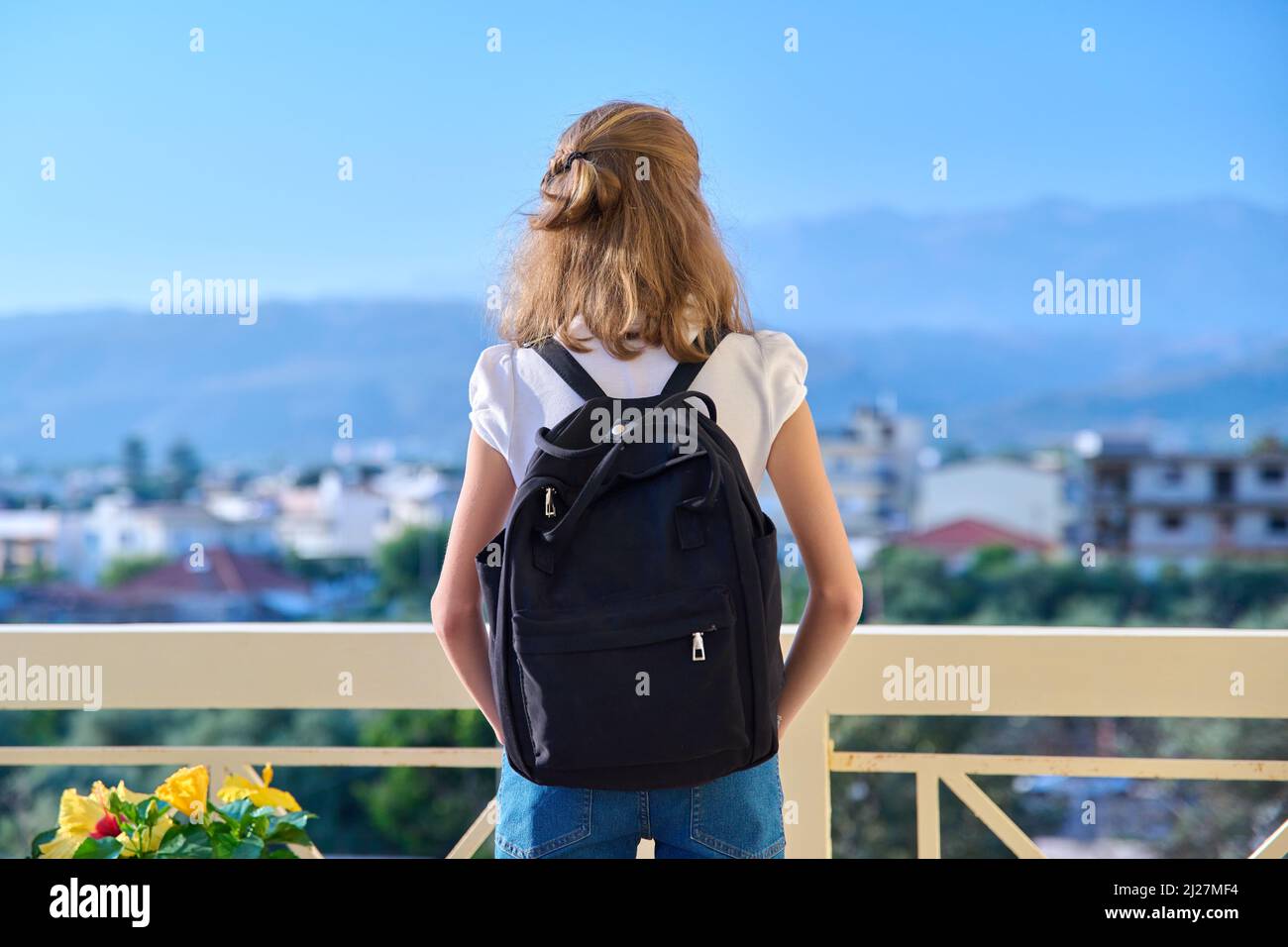 Back view, girl child with backpack outdoor Stock Photo - Alamy