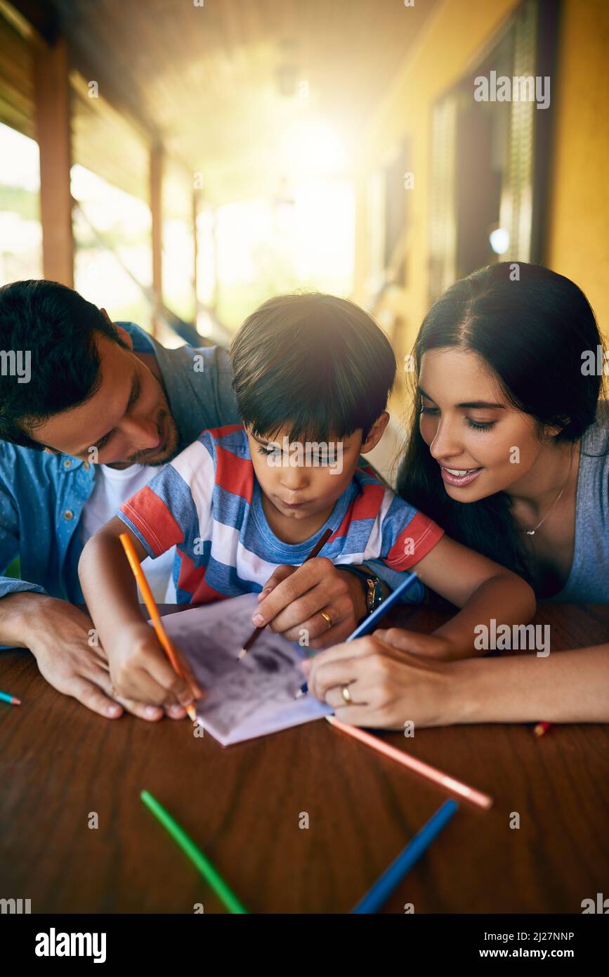 Learning to colour in the lines. Cropped shot of young affectionate ...