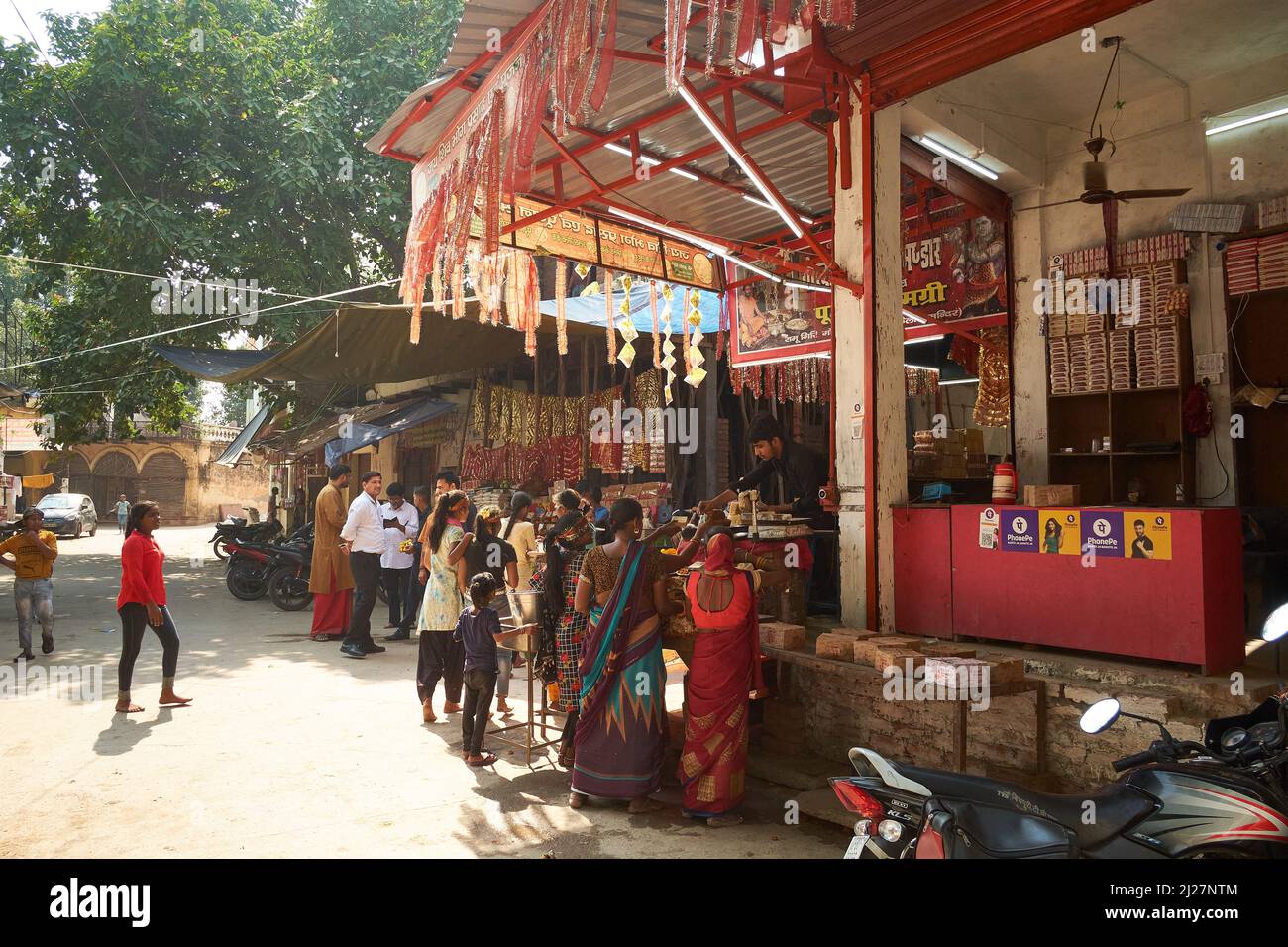 A typical snacks and confectionary shop in small town India. Motorcycles are a prominent part of ...