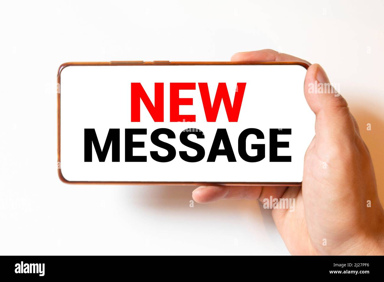 Hand holding mobile smart phone with one new message on a screen ...