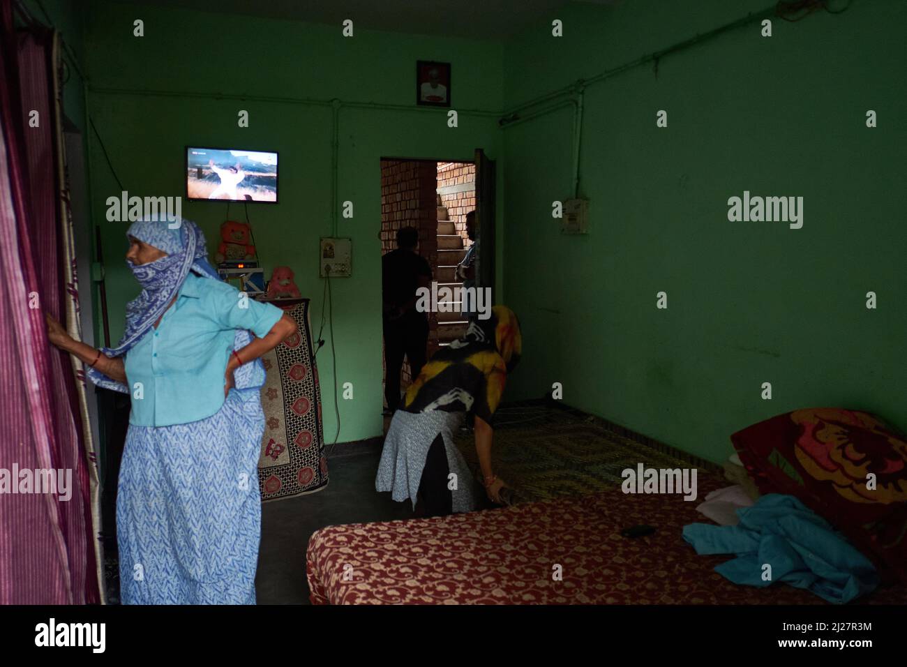 A traditionally dressed old woman in a typical modest house in Noida ...