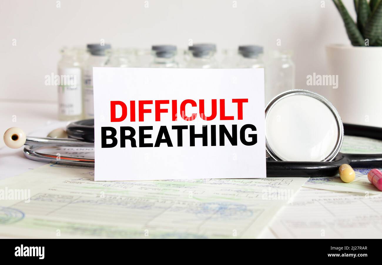 DIfficult breathing is a symptom written on a notebook on the medical ...