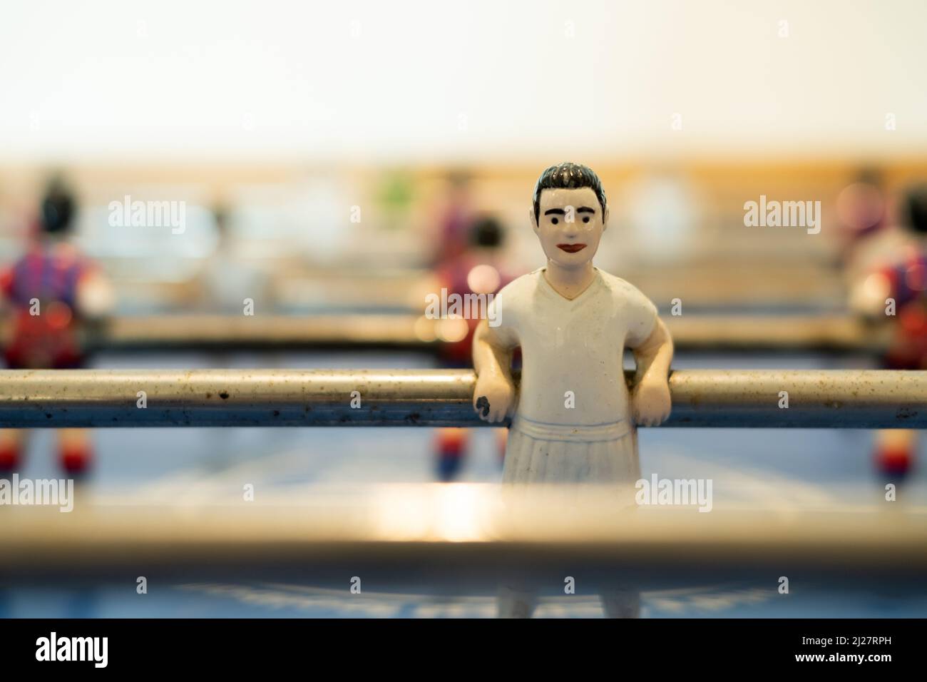 A table top bar football player shown relaxing against the bar he’s ...