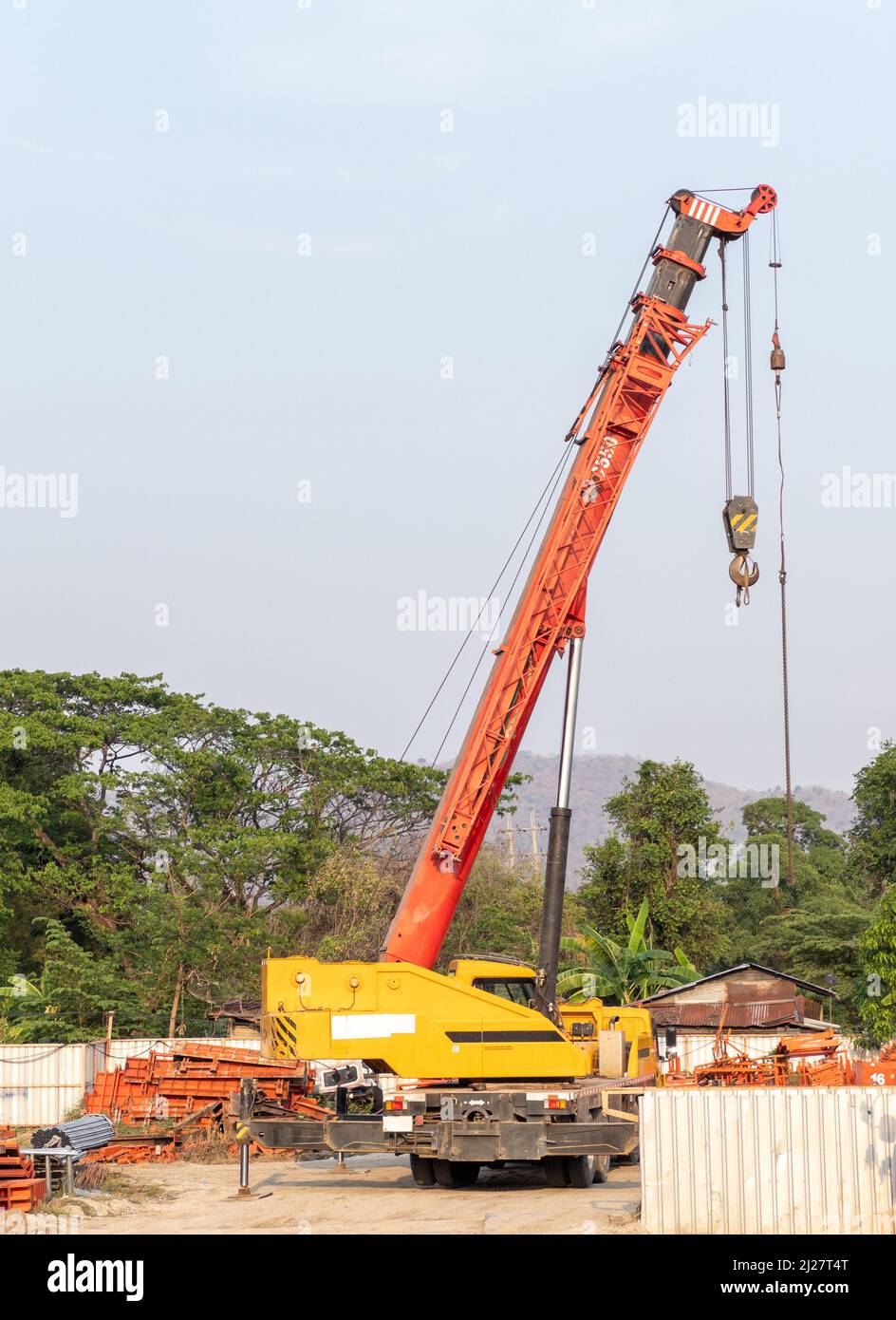 The large mobile crane with the long boom is ready to lift the metal ...