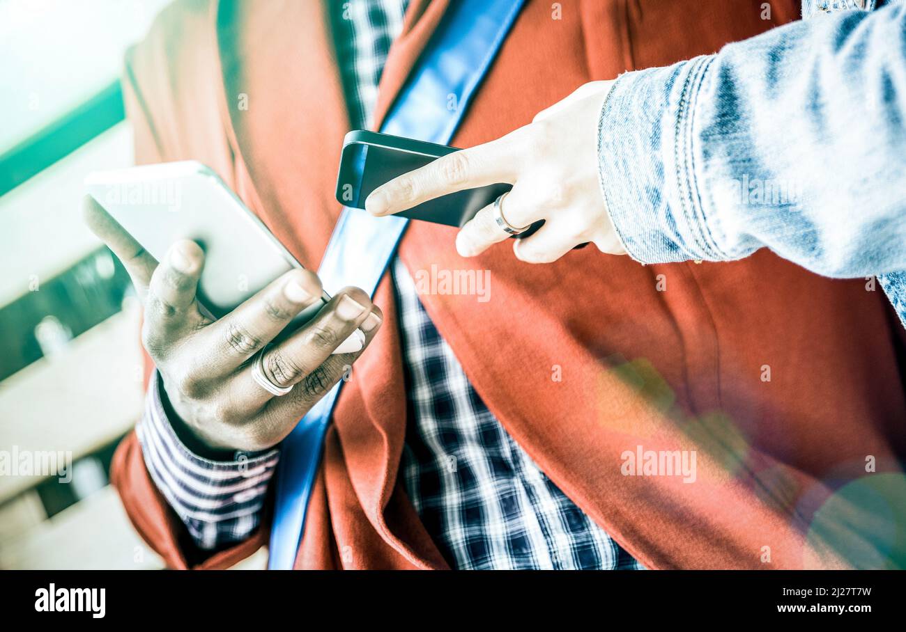 Close up detail of multiracial couple hands having fun with mobile ...