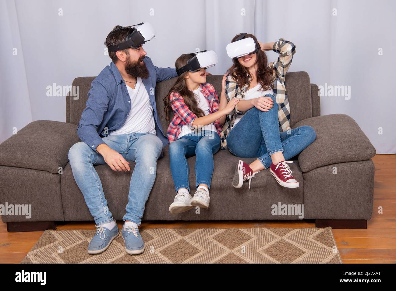 happy parents with kid girl use modern technology. mom dad and daughter ...